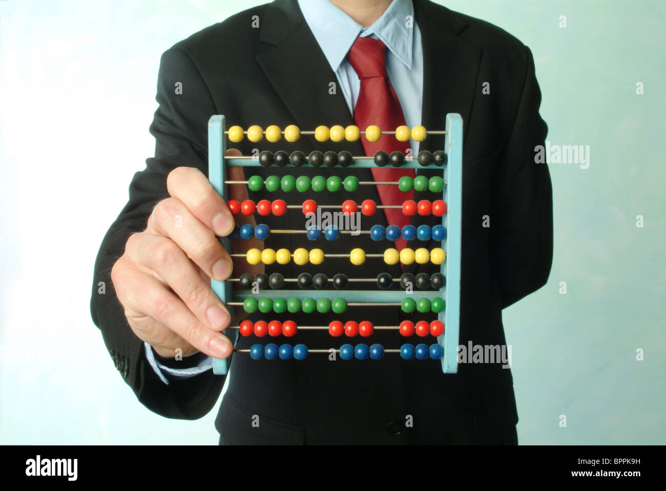 Man in a suit holding an abacus Stock Photo - Alamy