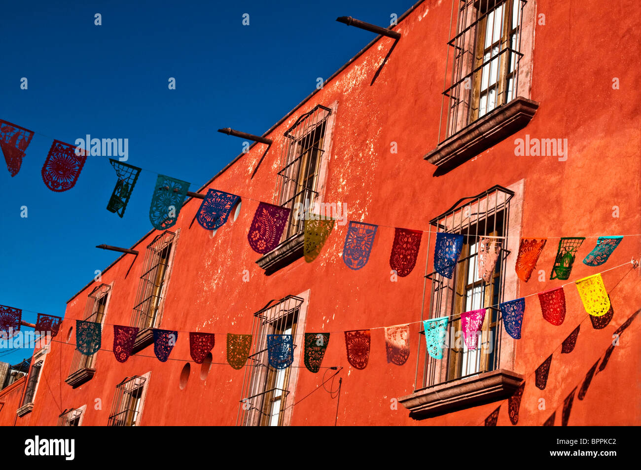 Mexico, San Miguel de Allende. Colorful banners strung across street ...