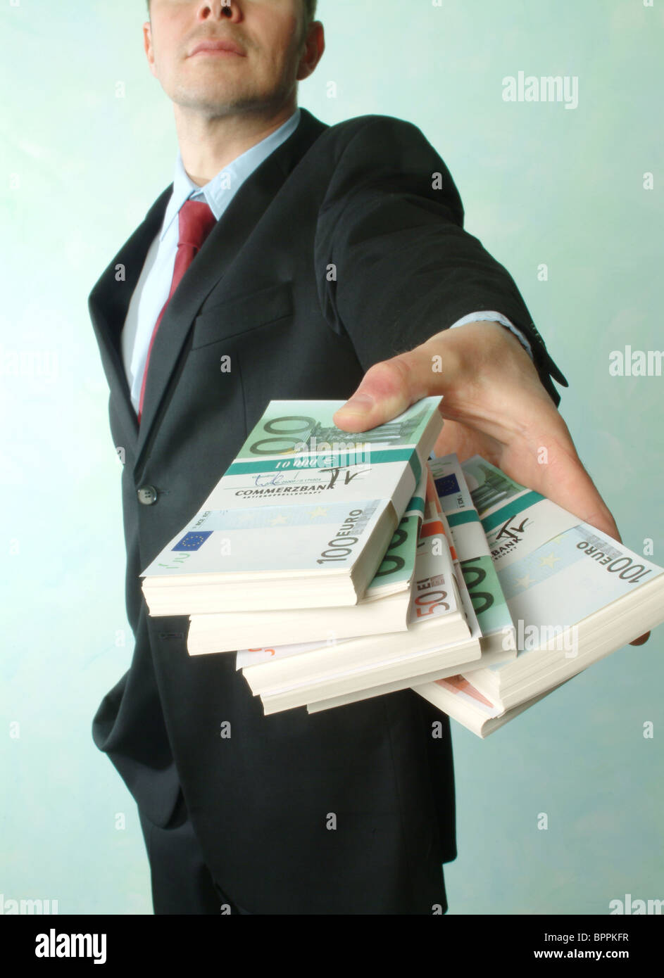 Man in a suit offering money Stock Photo - Alamy