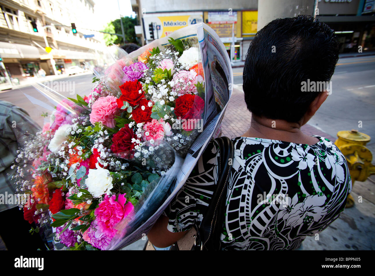 Woman carrying flowers, Broadway, Los Angeles, California, United ...