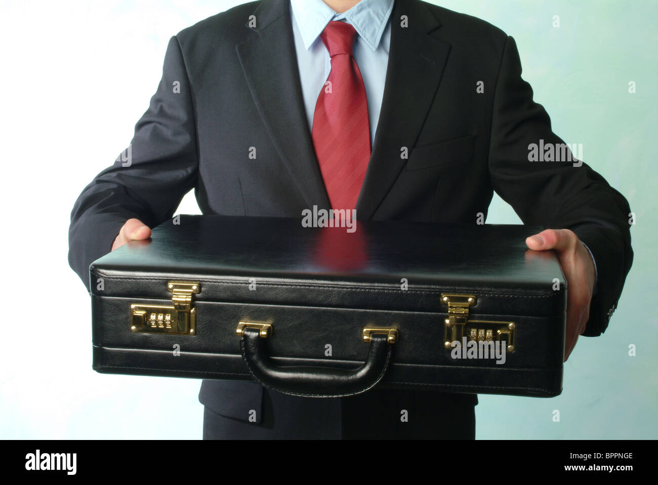 A man showing a closed briefcase Stock Photo - Alamy