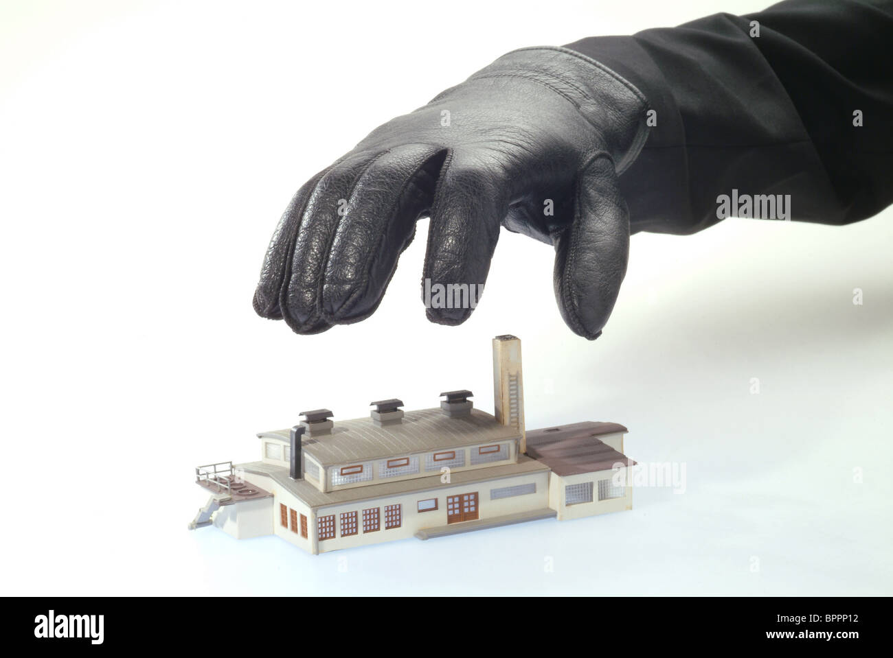 Black-gloved hand reaching for a factory model Stock Photo - Alamy