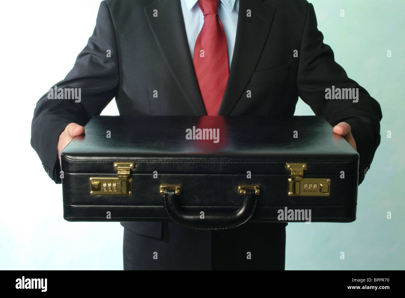 A man showing a closed briefcase Stock Photo - Alamy