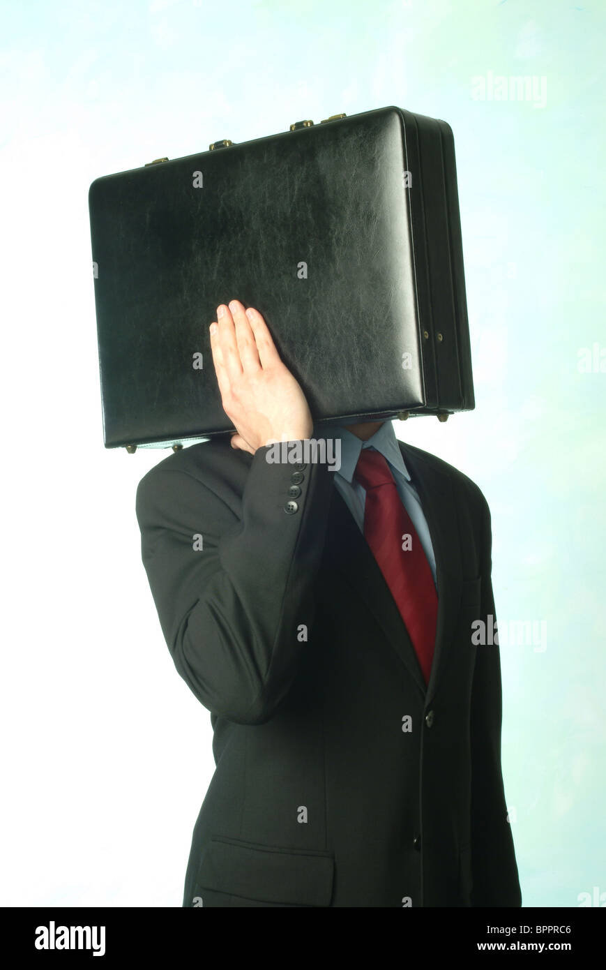 A man holding a briefcase to the side of his head Stock Photo - Alamy