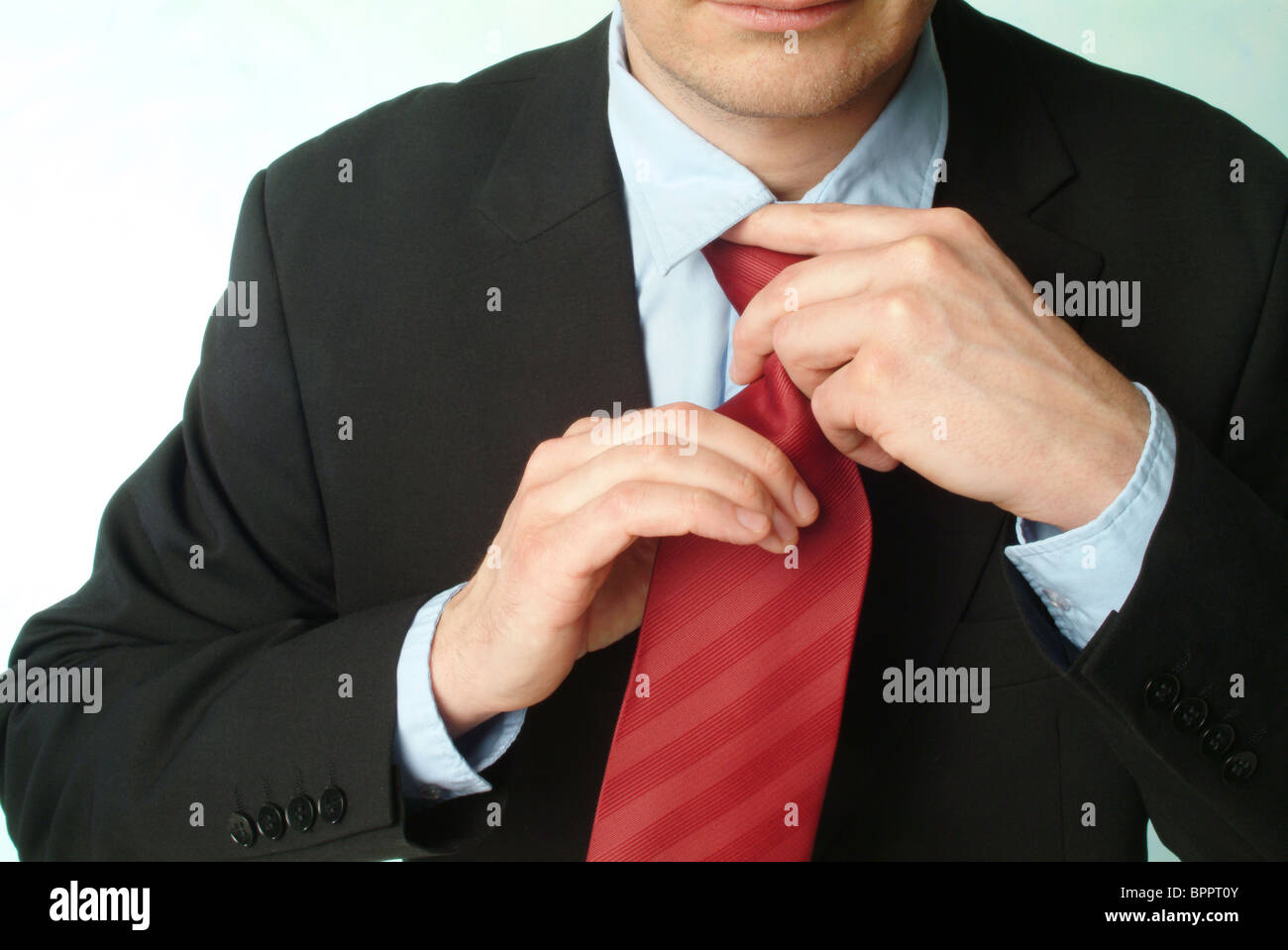 Man tying his tie Stock Photo - Alamy