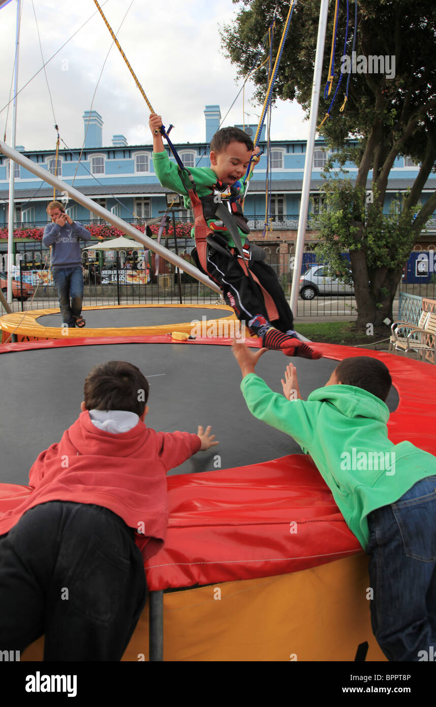 Children playing on a bungee trampoline, UK Stock Photo - Alamy