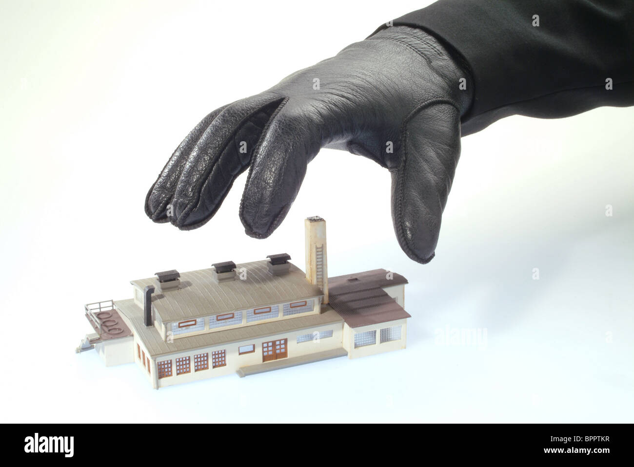 Black-gloved hand reaching for a factory model Stock Photo - Alamy