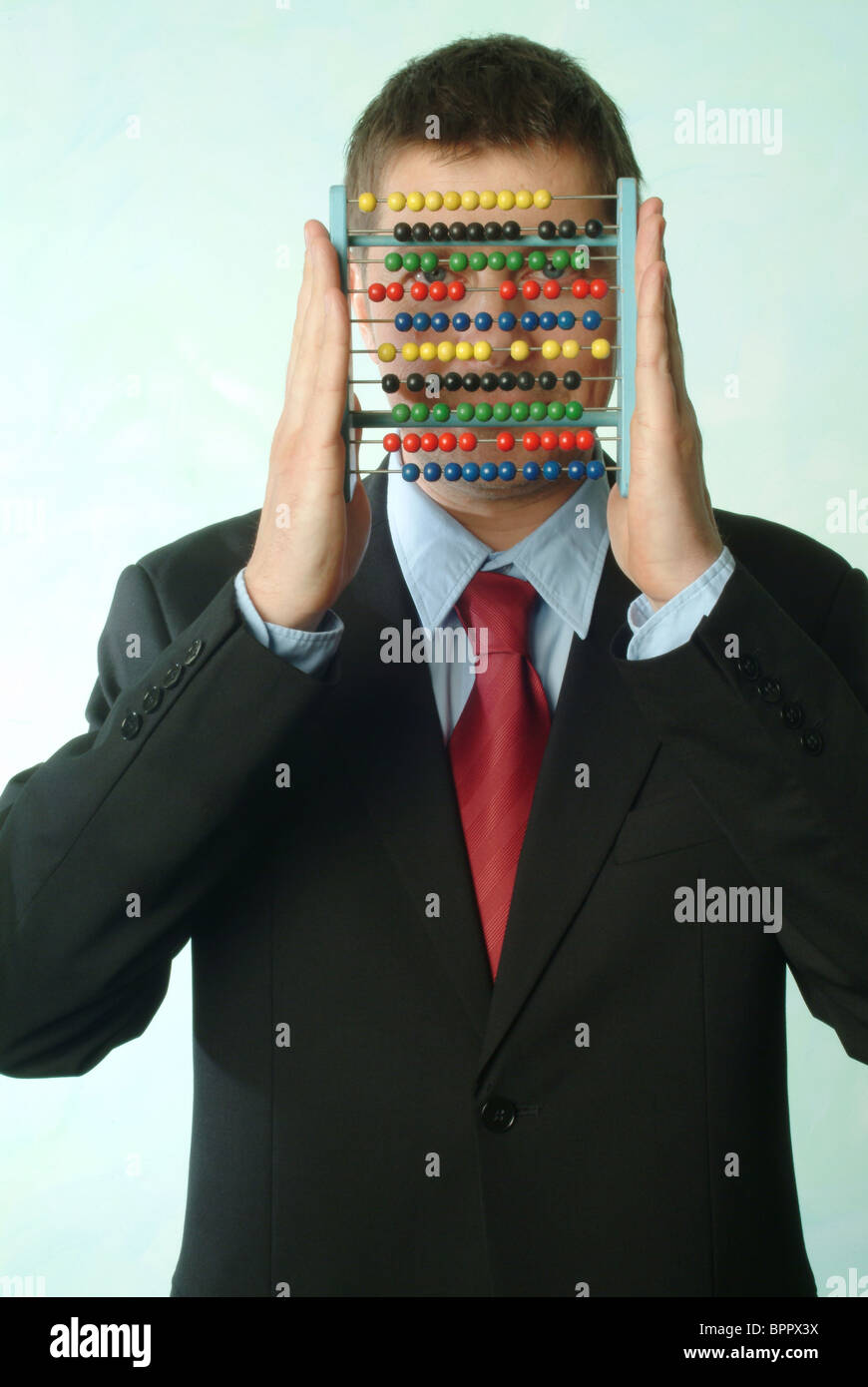 Man in a suit holding an abacus Stock Photo - Alamy