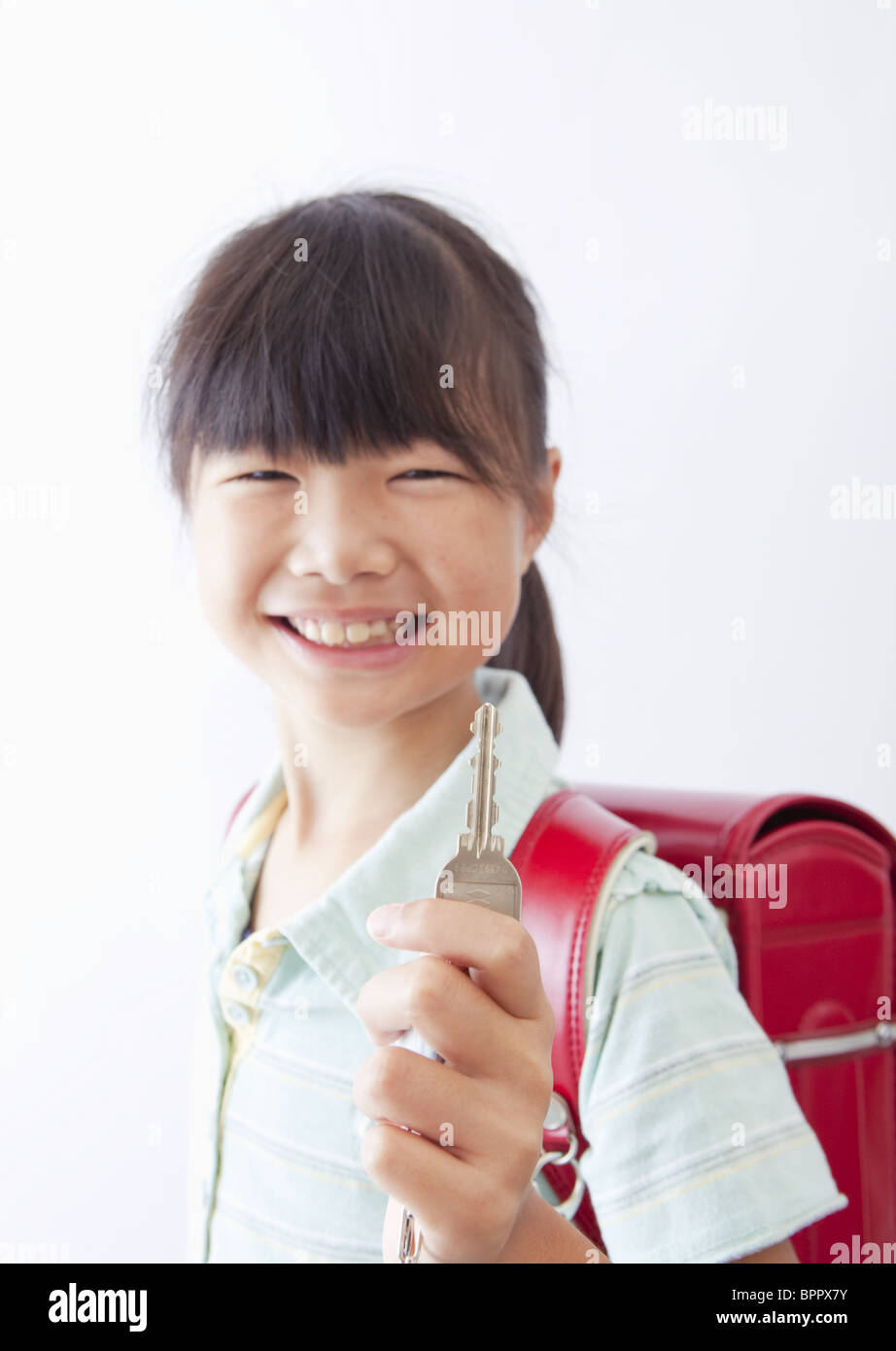 Girl holding a key Stock Photo - Alamy