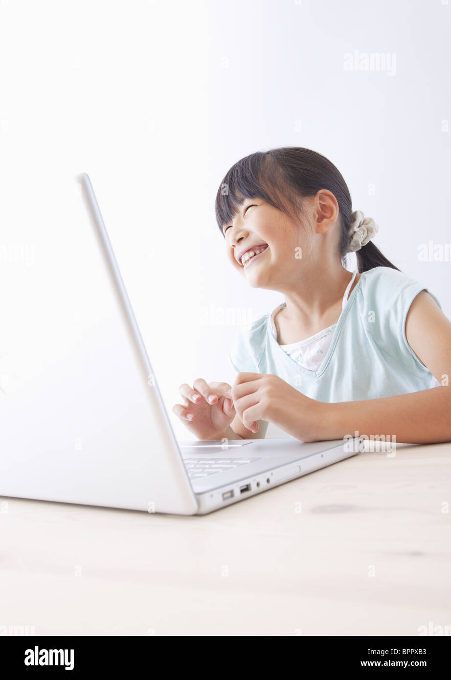 Girl studying with a laptop computer Stock Photo - Alamy