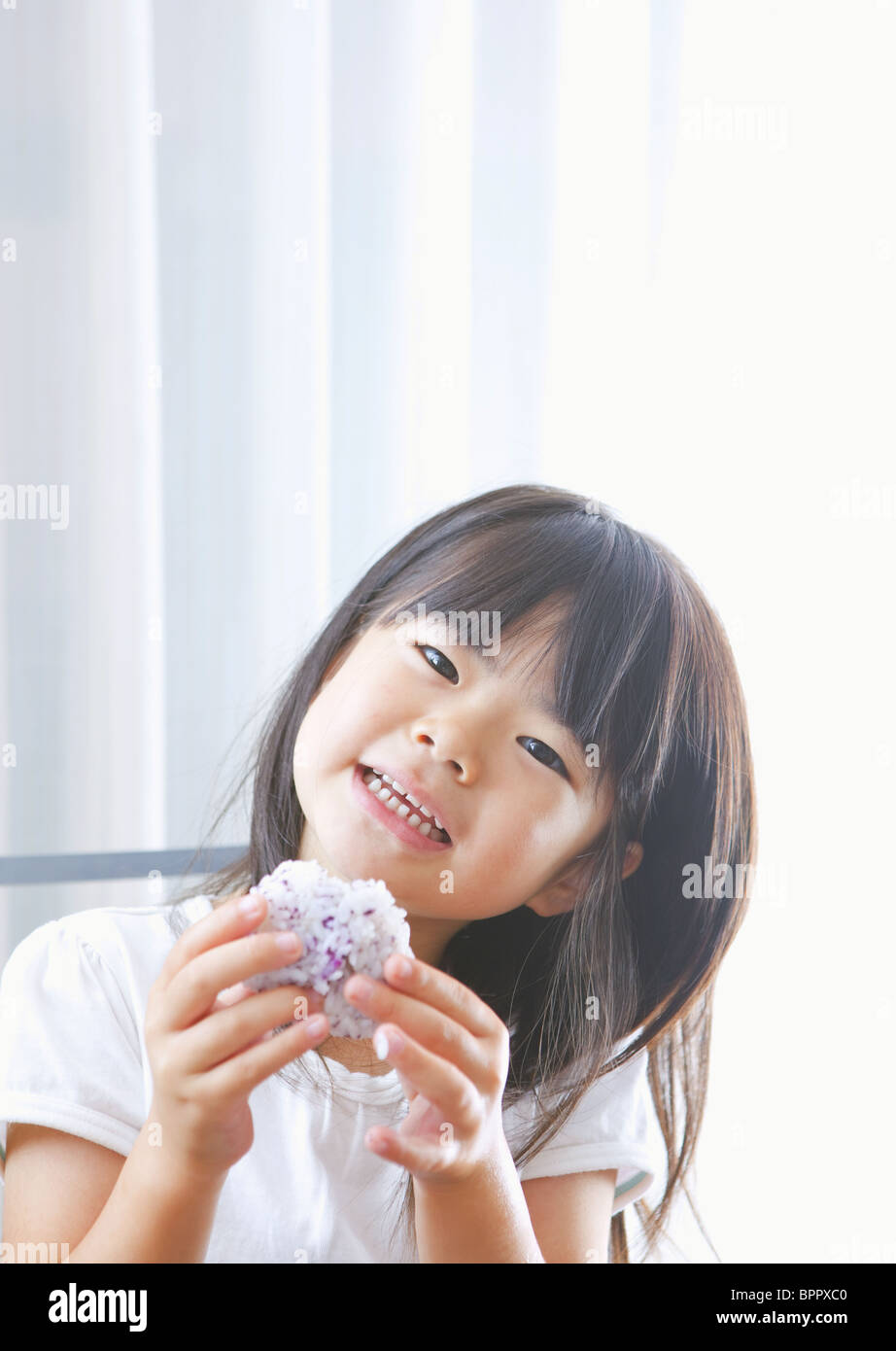 Girl eating rice ball hi-res stock photography and images - Alamy