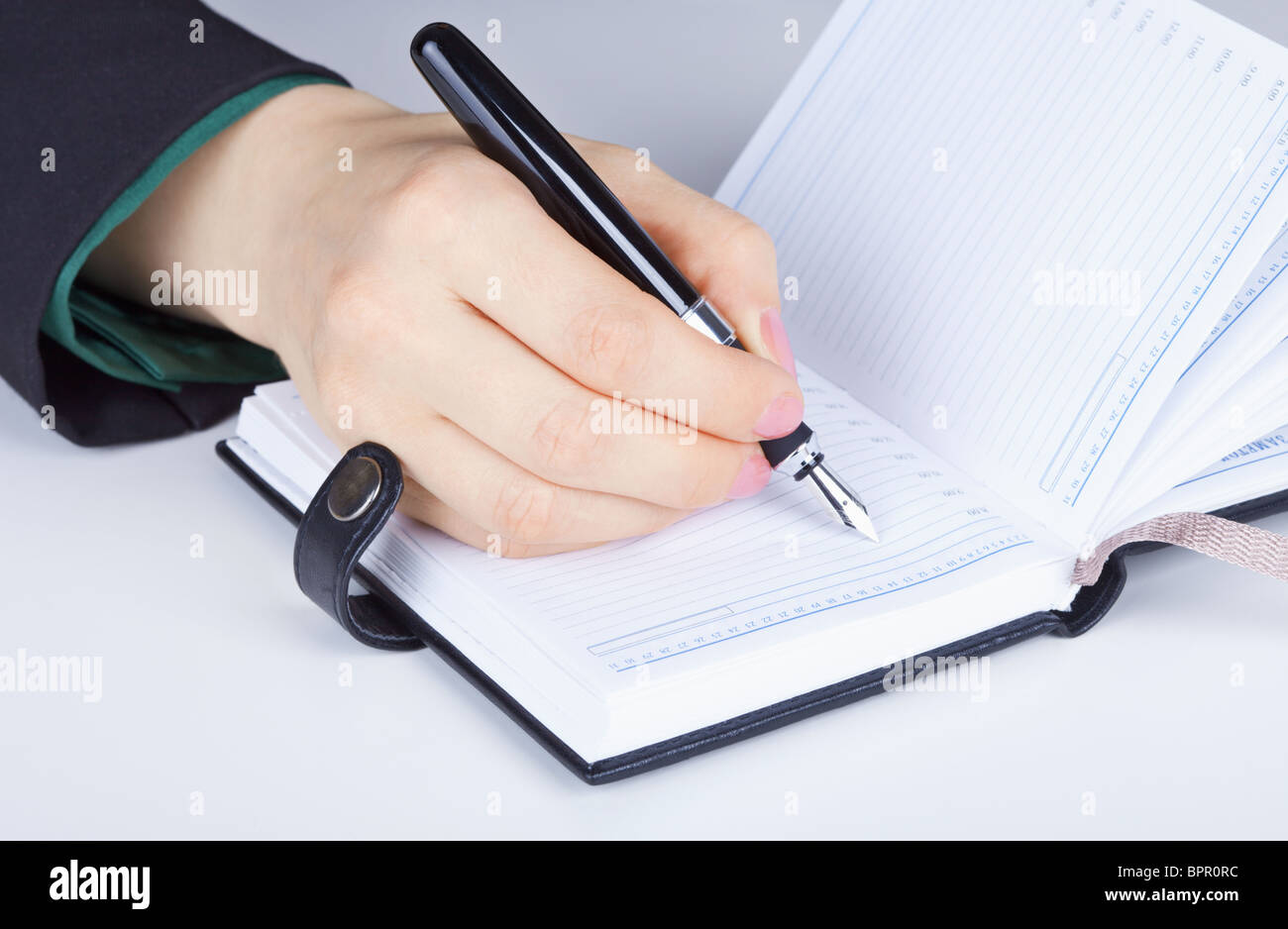 The women's hand and writes in diary Stock Photo - Alamy