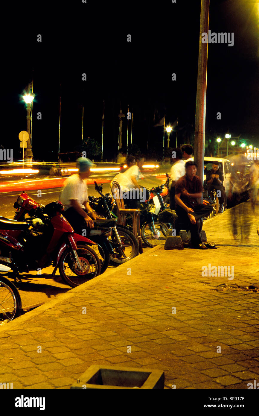 Moto drivers sleeping and relaxing on vehicles on street near the Tonle ...