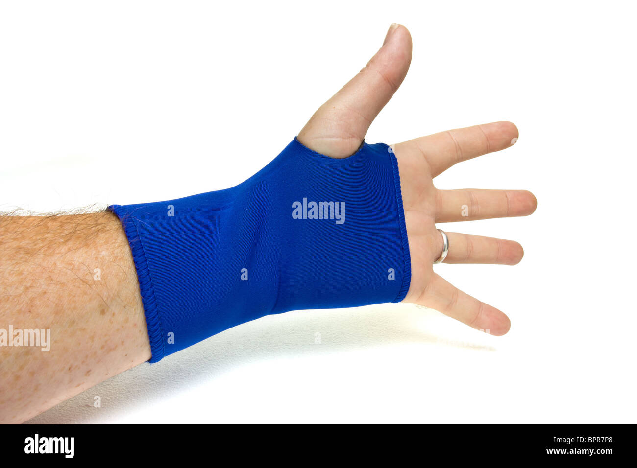 Male hand gesturing wearing blue neoprene wrist support over white ...