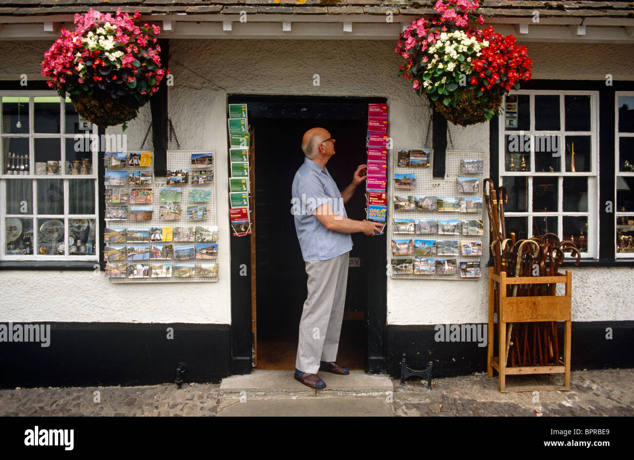 A shopkeeper makes final adjustments to his stock outside his tourist ...