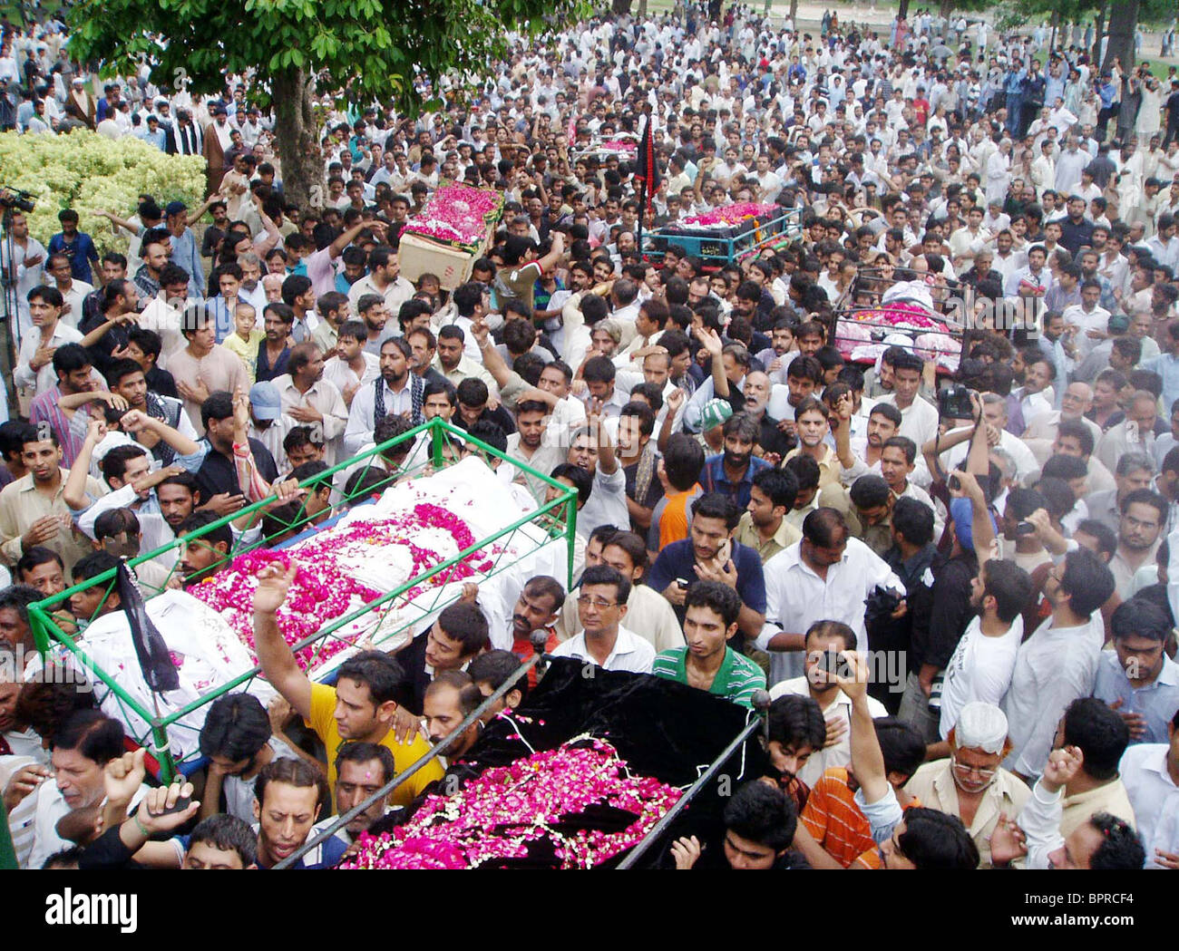 People carry coffins of those, who were lost their lifes in bomb ...