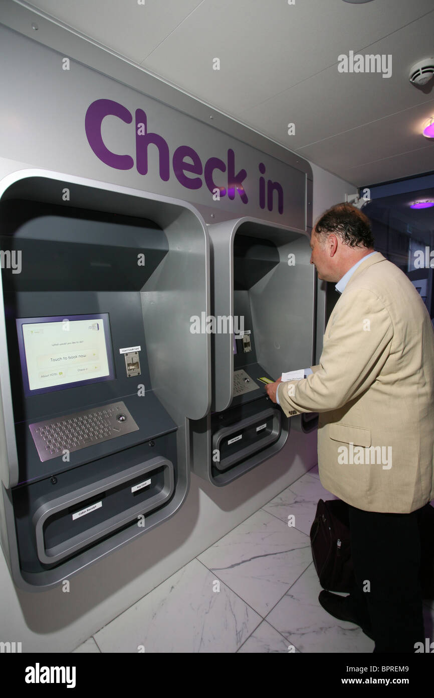 Image shows a man staying at Yotel, a budget hotel made of tiny cabins ...