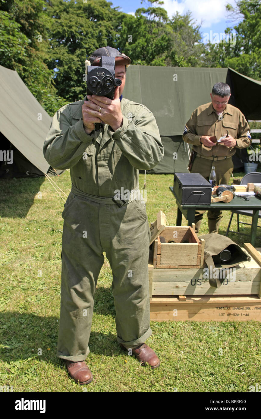 WW2 Reenactment Member in the US Army using a clockwork cine camera ...