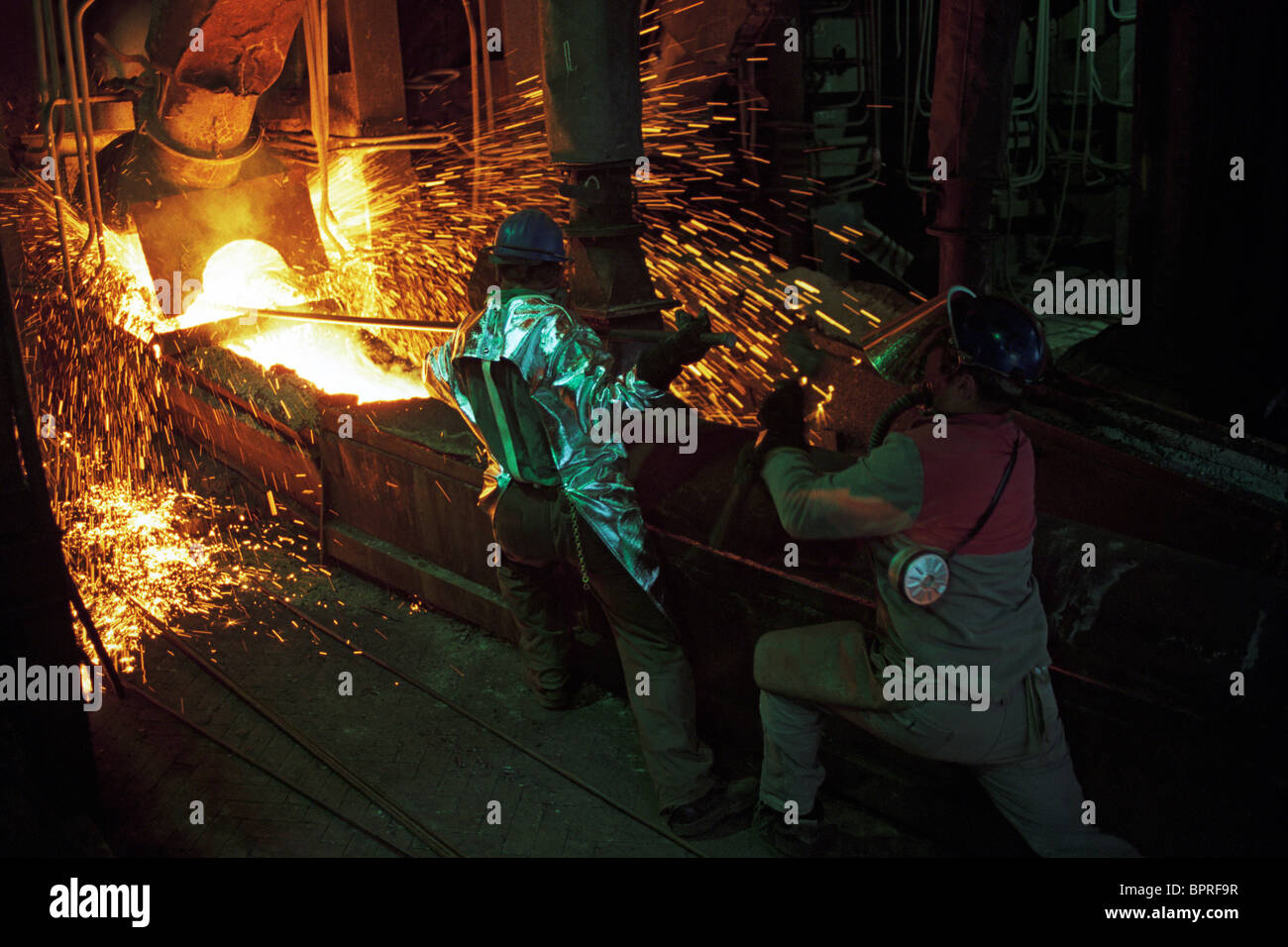 Bulgarian copper manufacturing workers tend to molten metals in the ...