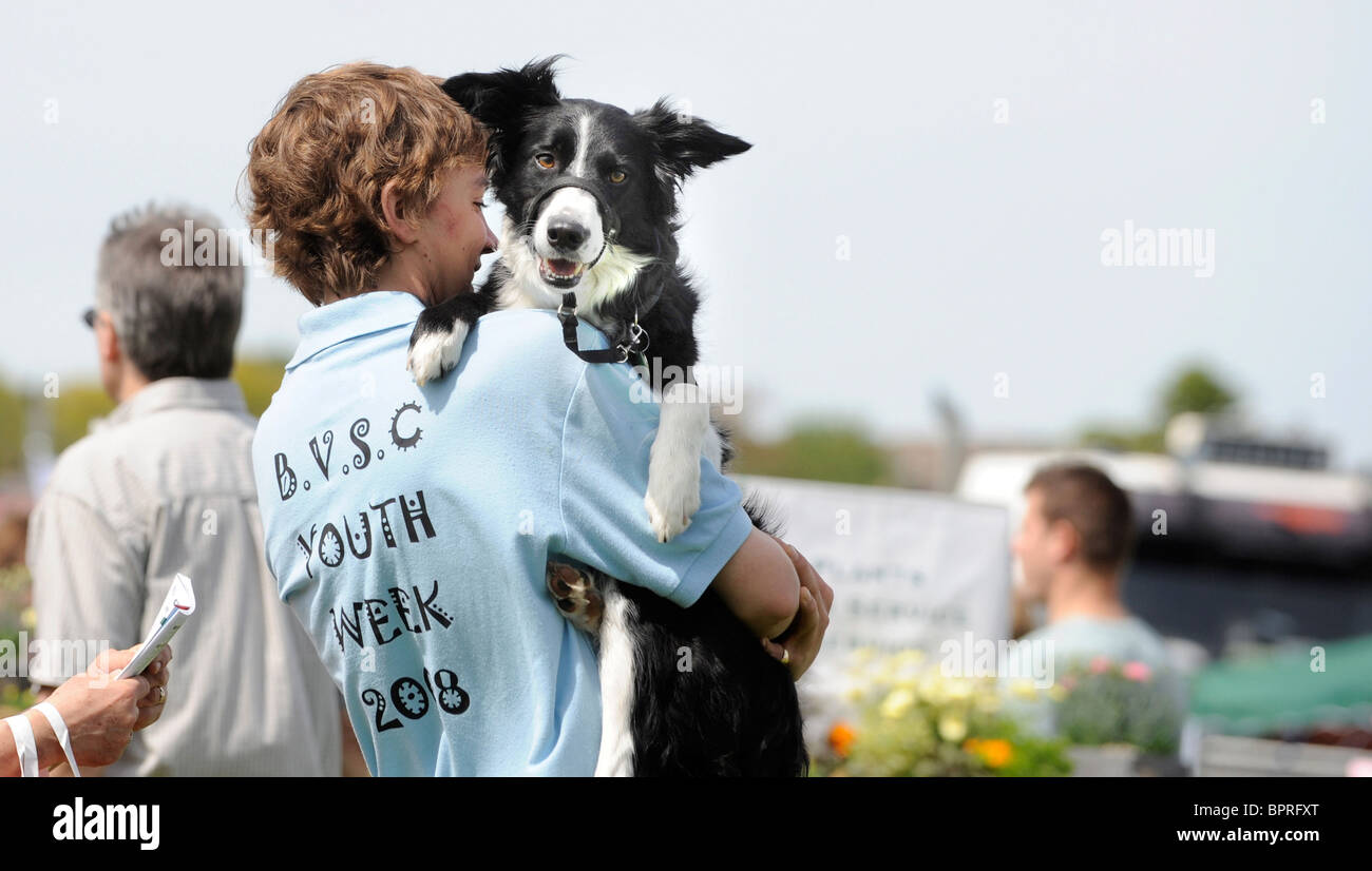 A teenage boy carrying his pet dog over his shoulder Stock Photo - Alamy