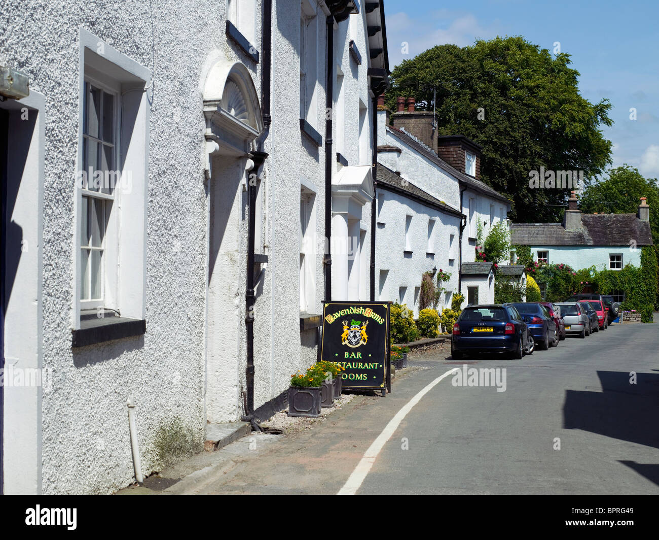 Parked cars outside the Cavendis Arms bar pub public house in summer ...