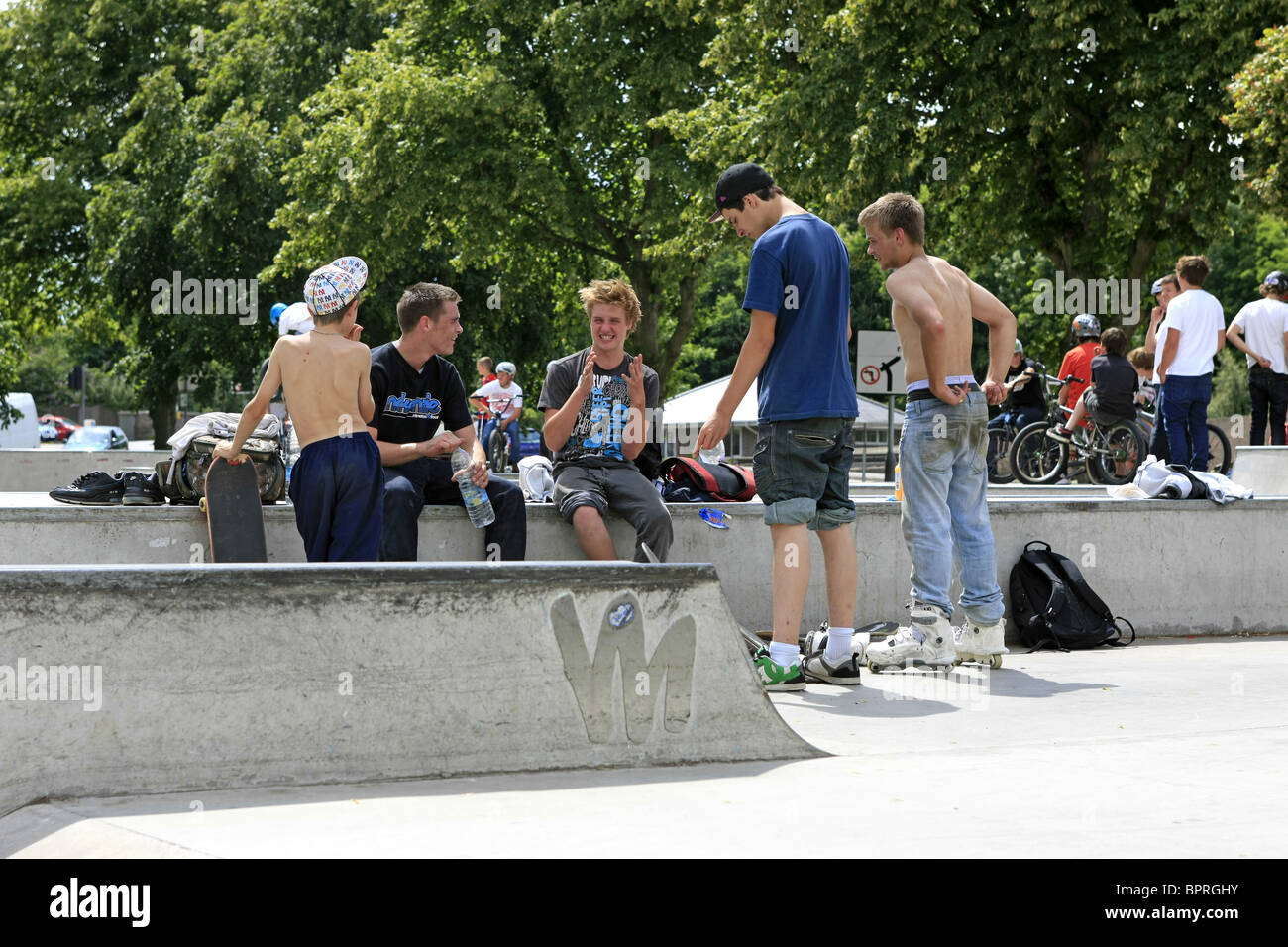 Tenage boys talk about girls and roller-blading at a specific designed ...