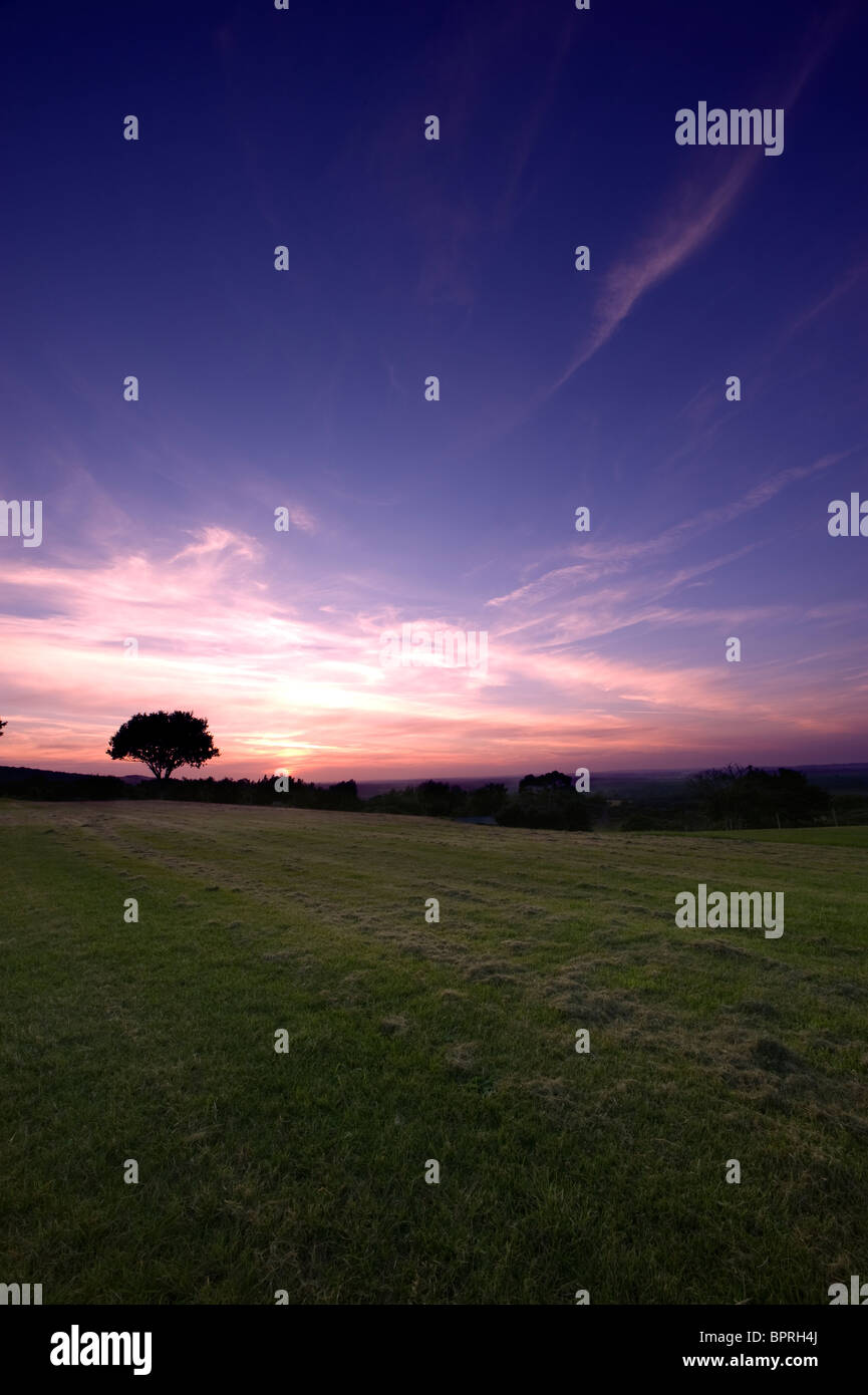 Sun setting over Isle of Purbeck in Dorset, UK Stock Photo - Alamy