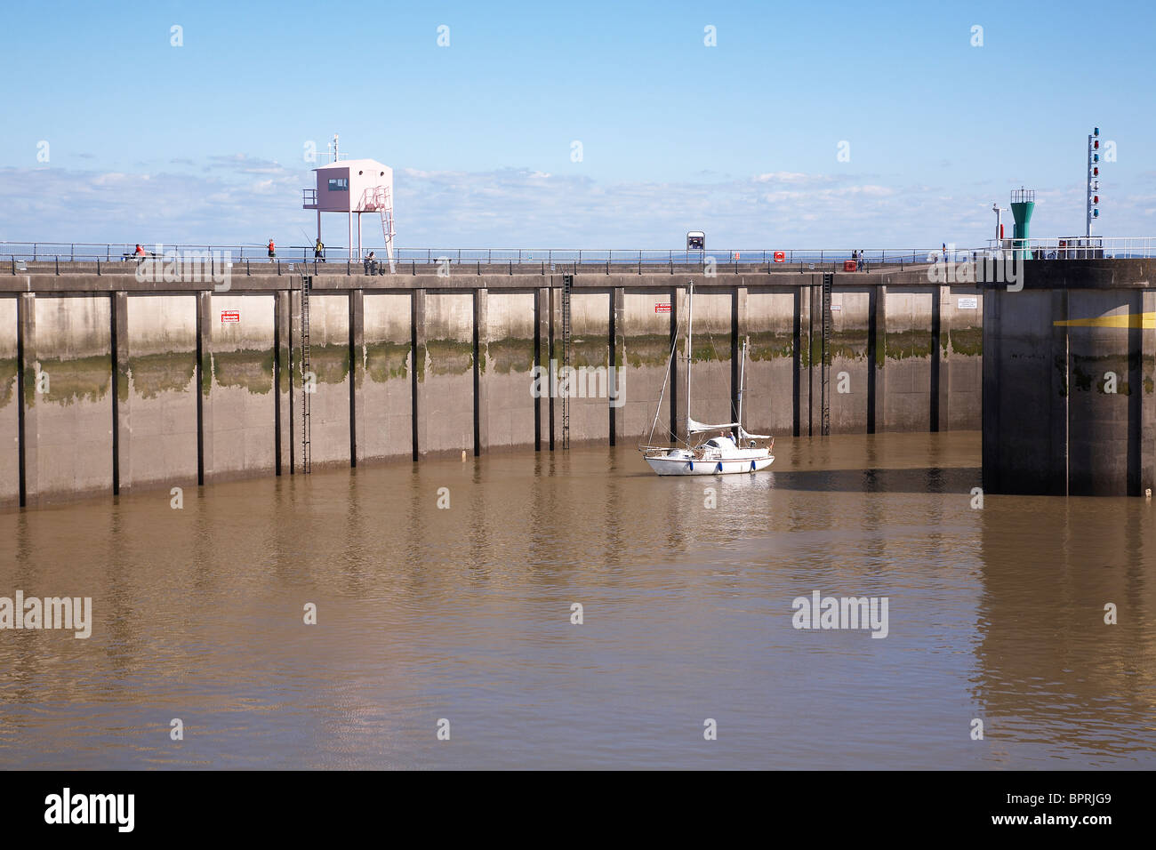 Yacht entering dock entrance waiting to enter lock to Cardiff bay ...