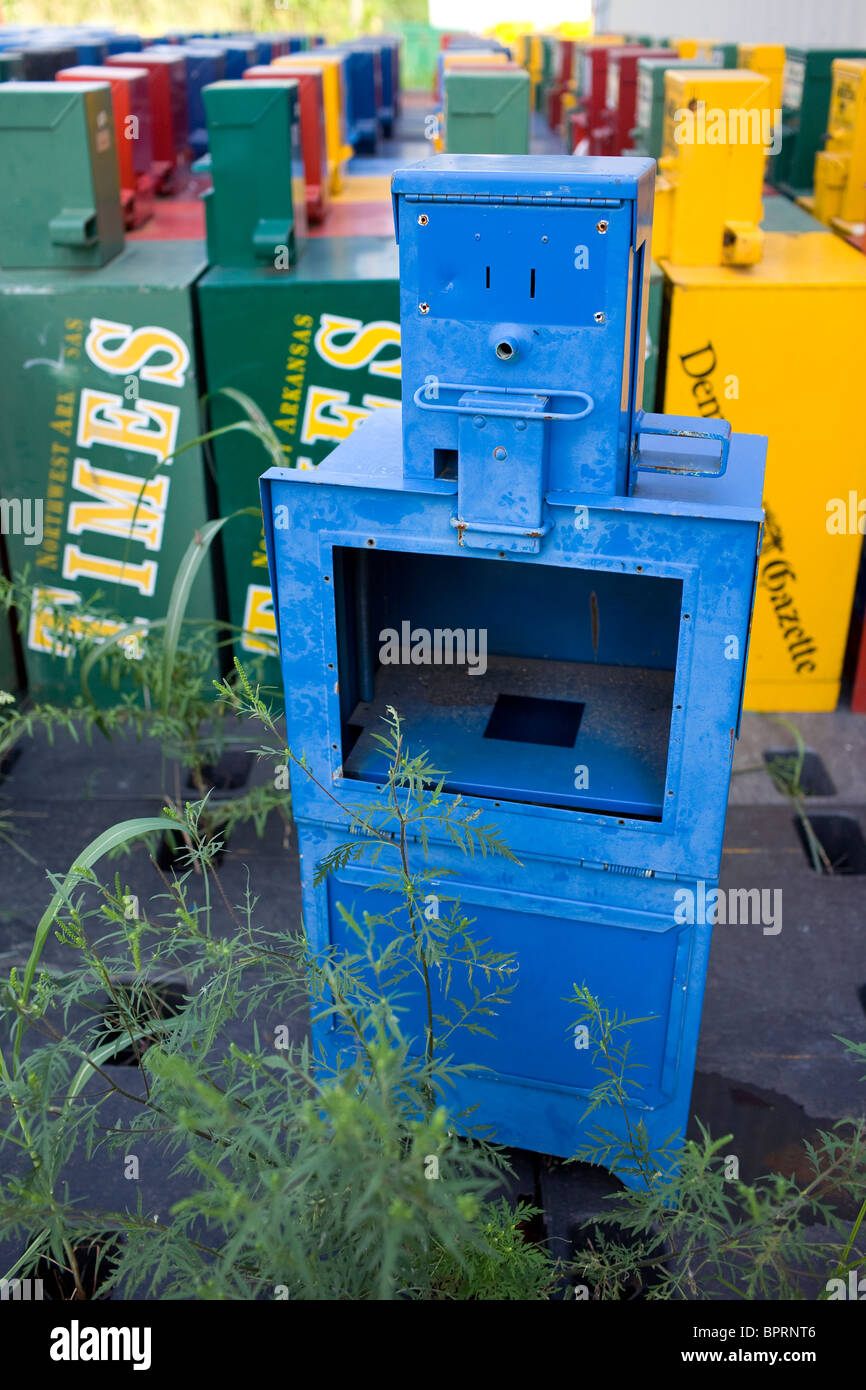 A surplus newspaper box possessing a human-like expression sits behind ...