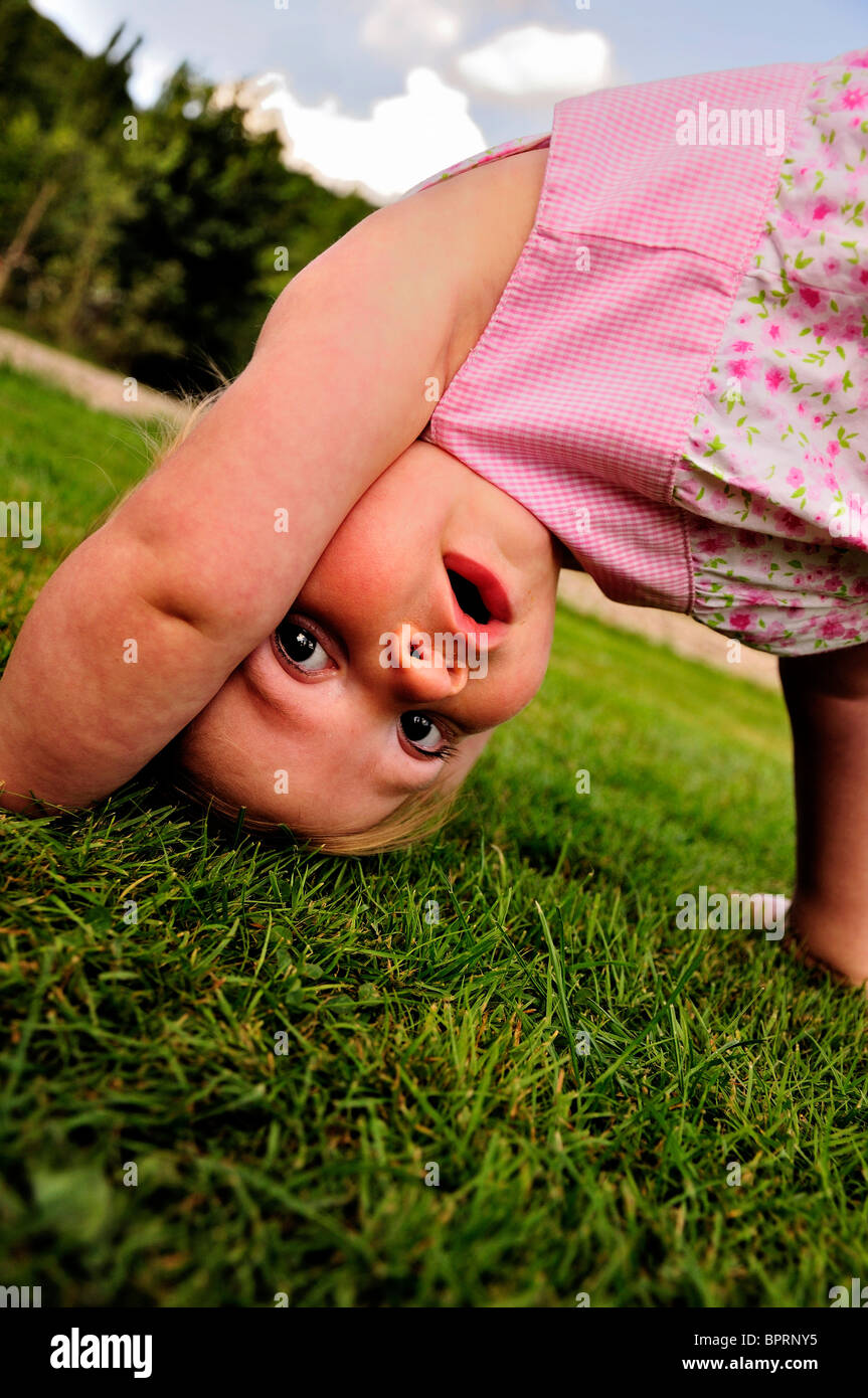 Small child upside down doing a handstand Stock Photo - Alamy
