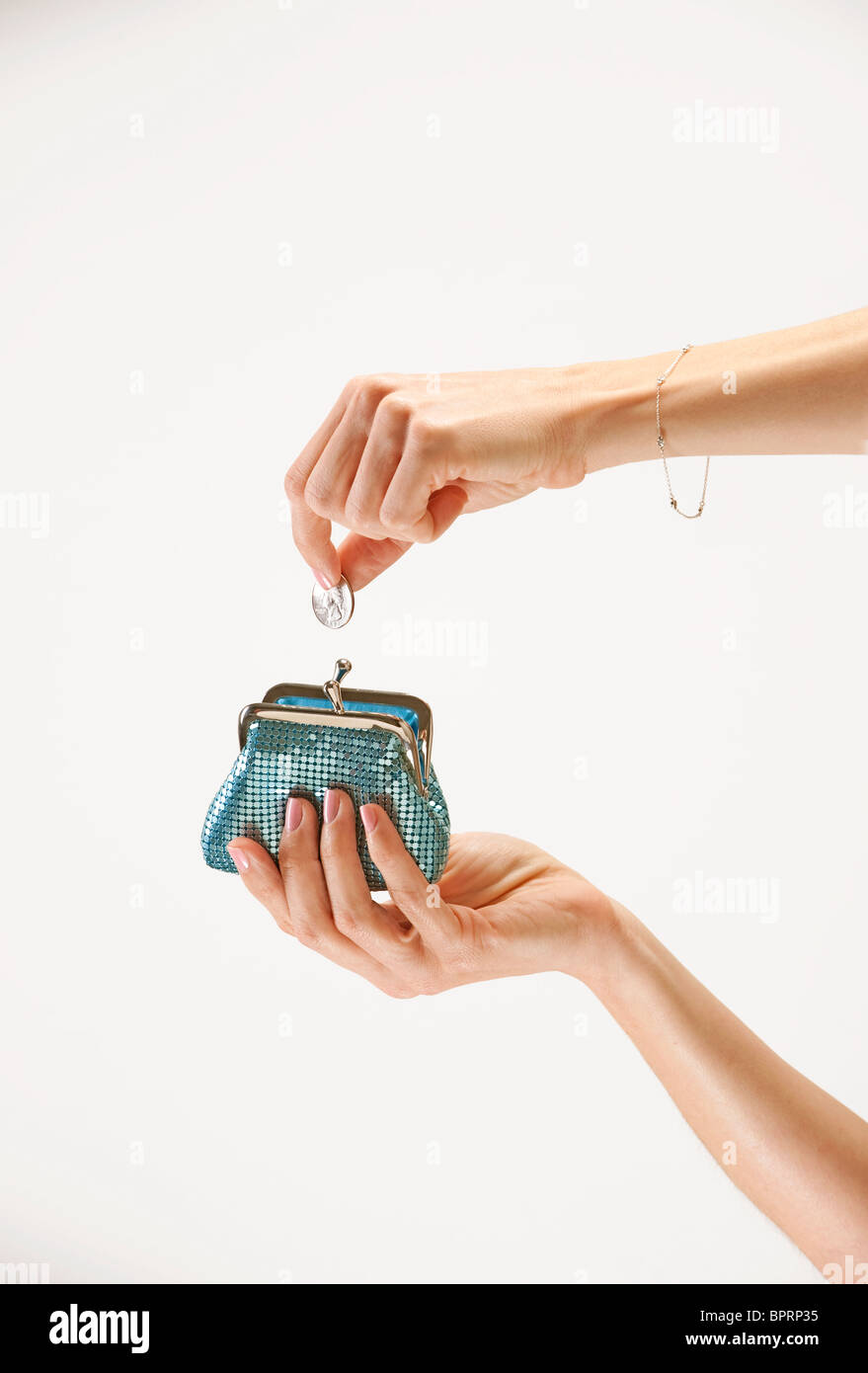 woman takes quarter from her blue coin purse Stock Photo - Alamy