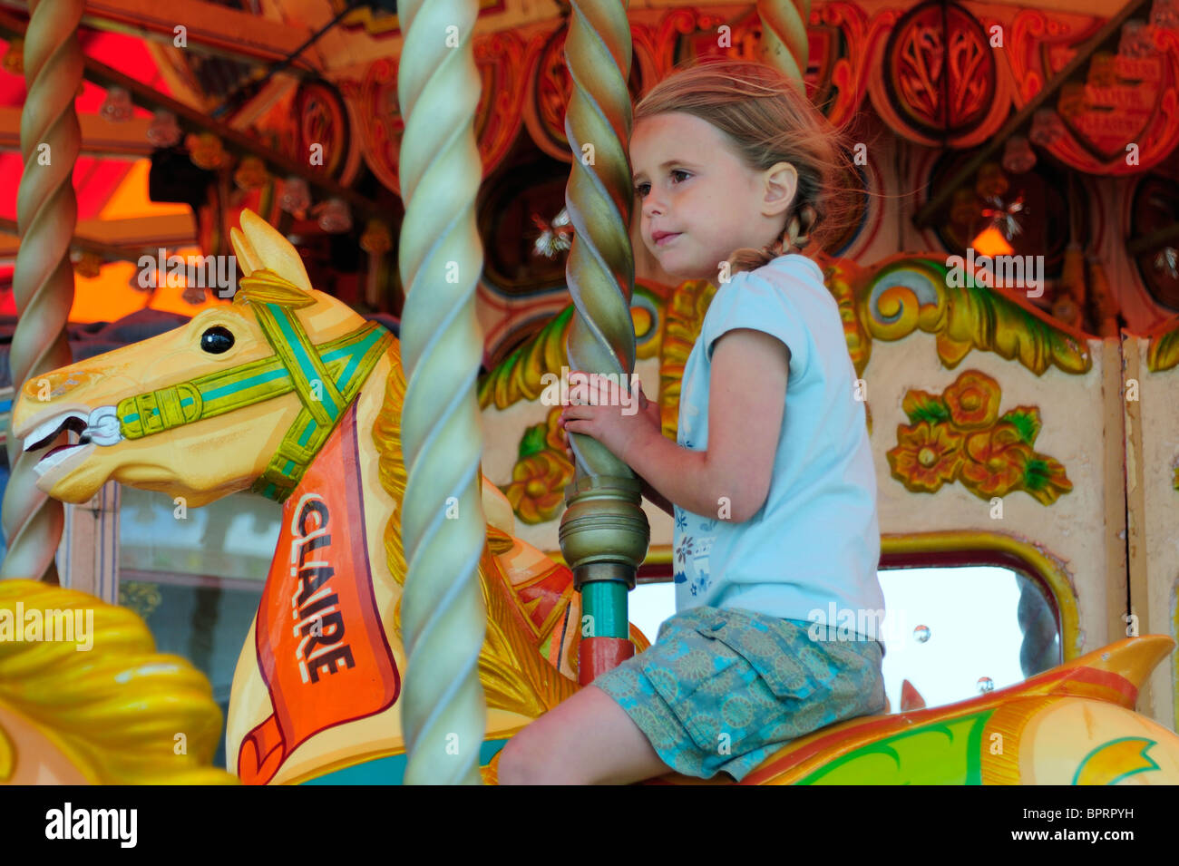 Young girl riding carousel horse hi-res stock photography and images ...