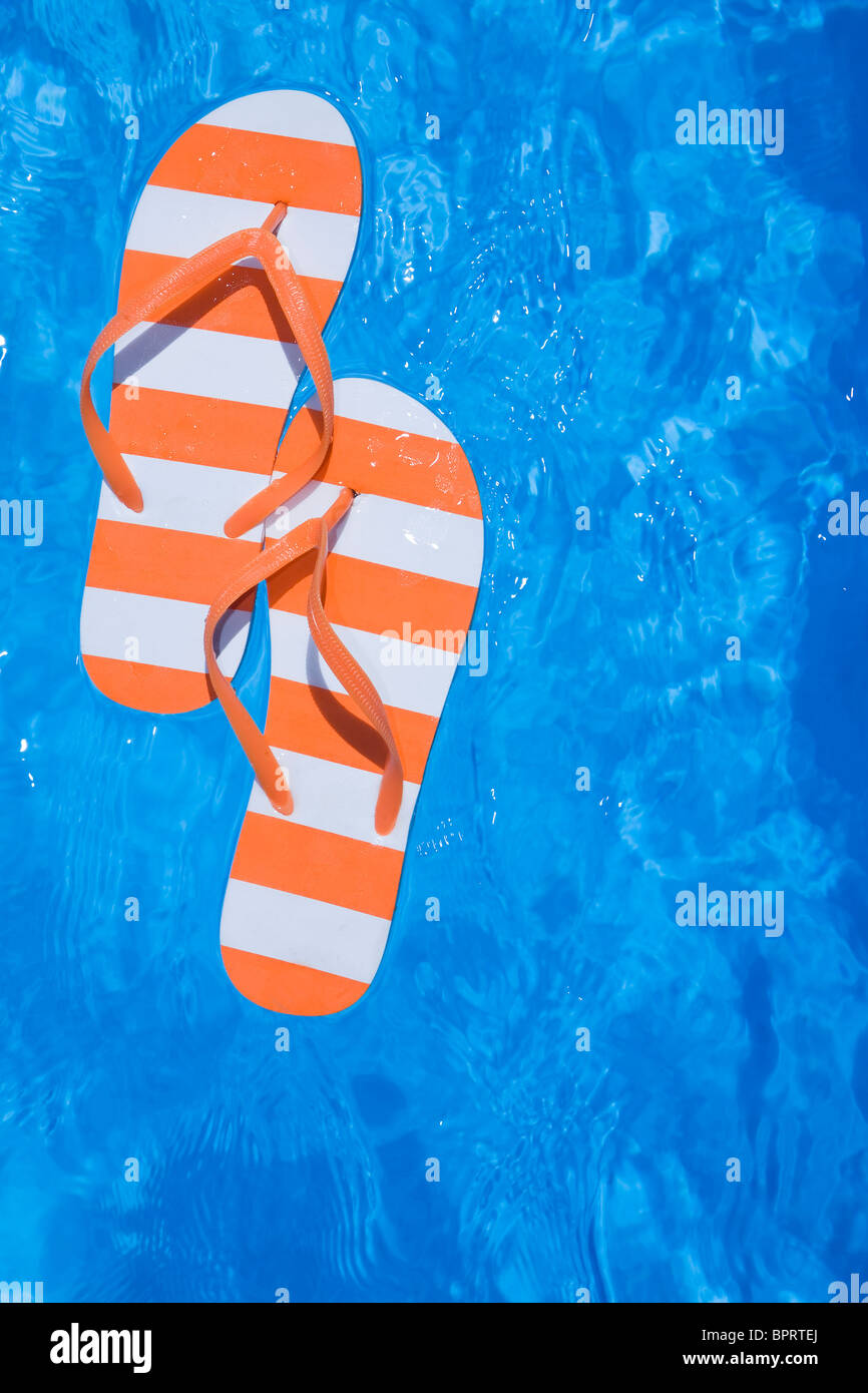 Pretty pair of stripey flip flops or thongs in a sparkling blue ...