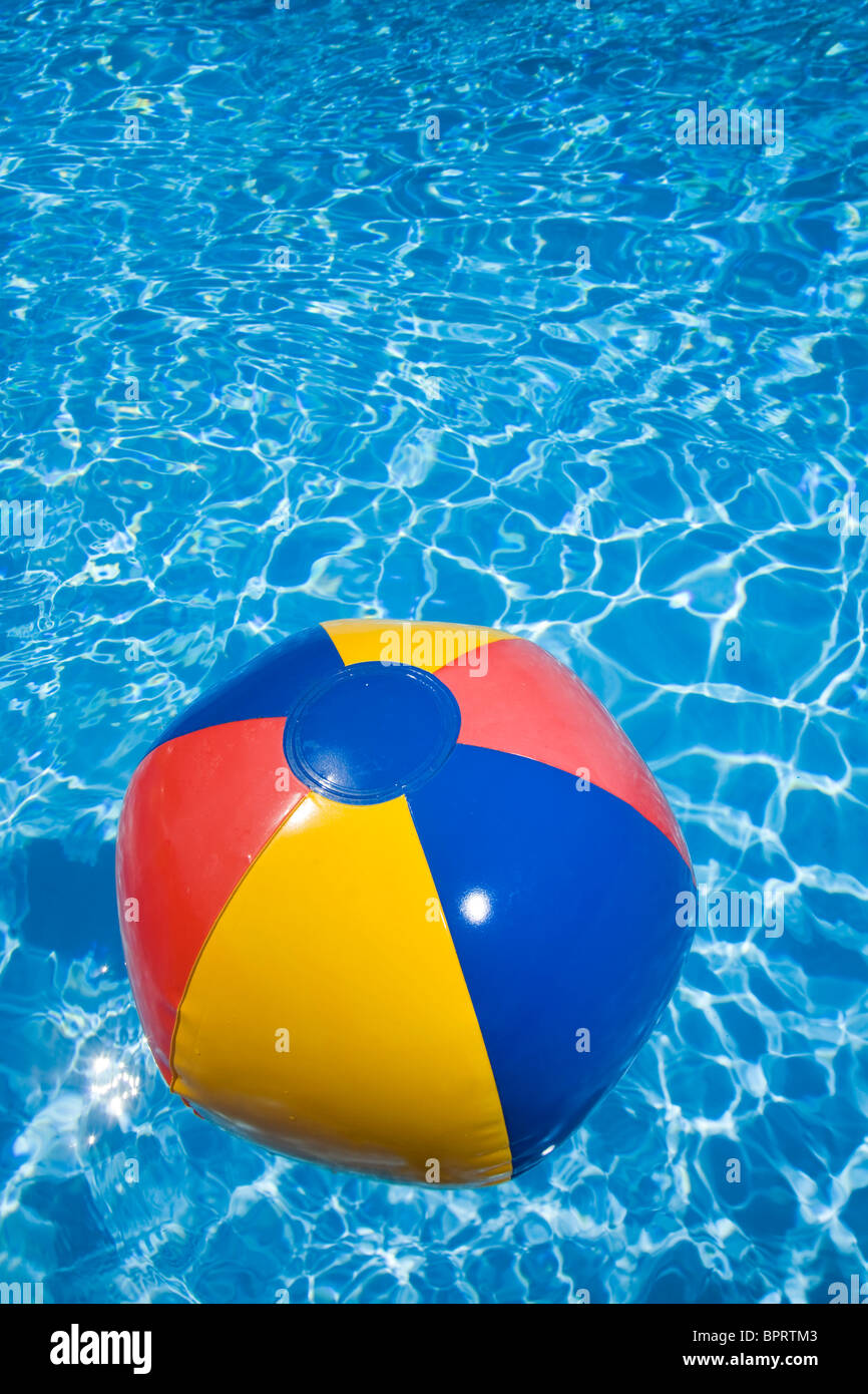 Beach ball in a sparkling blue swimming pool Stock Photo - Alamy