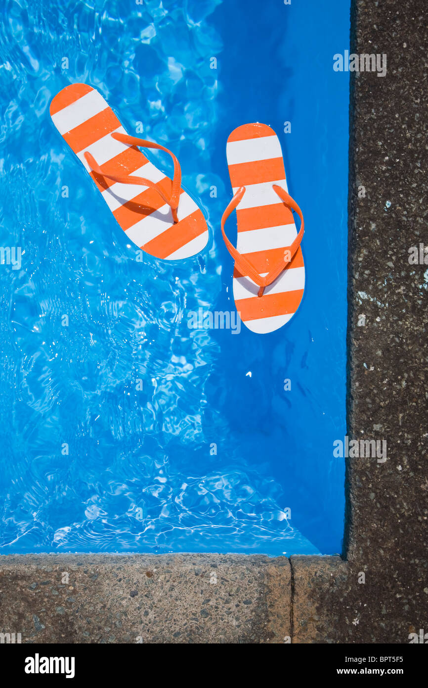 Pretty pair of stripey flip flops or thongs in a sparkling blue ...