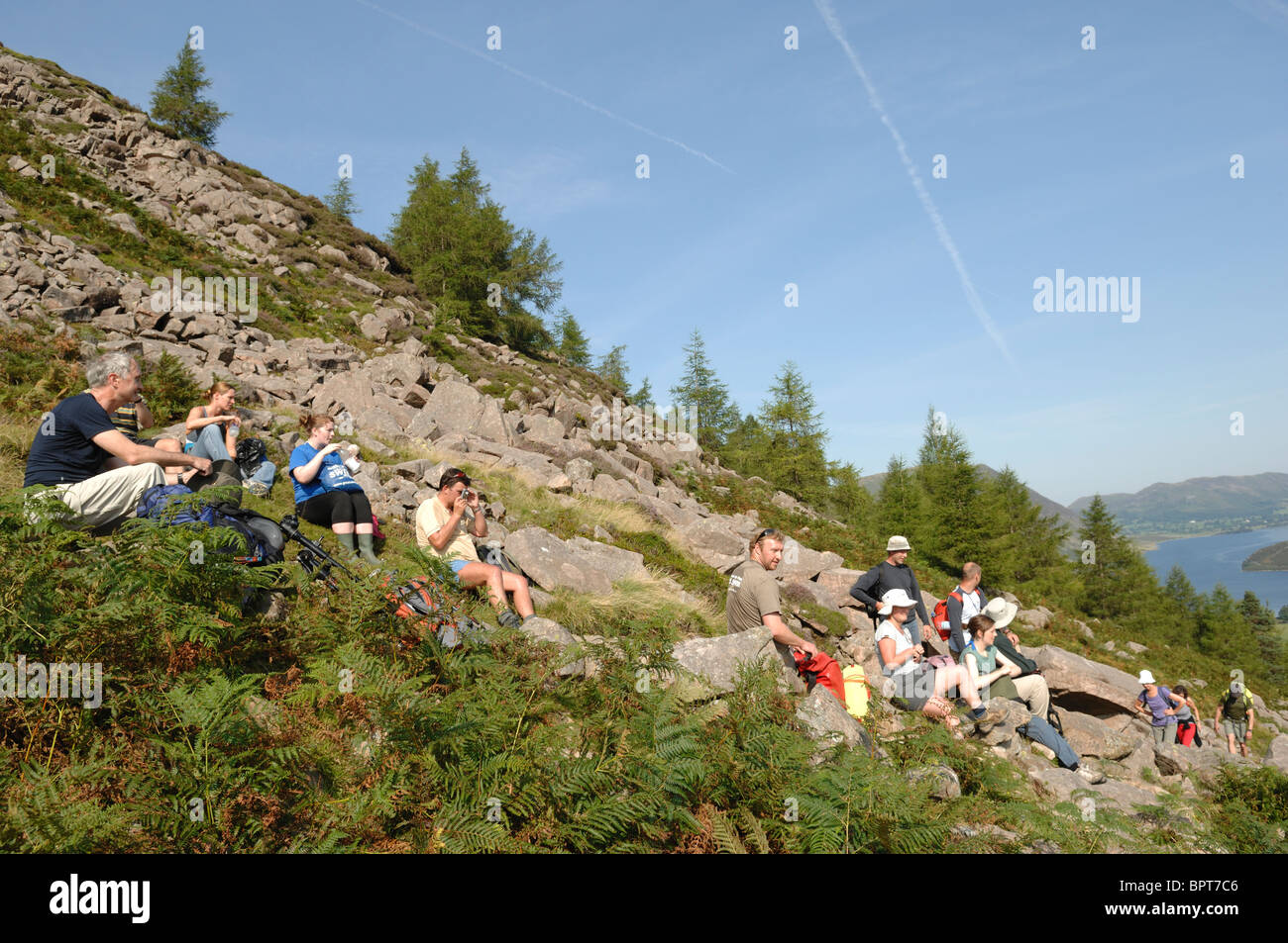 Group of walkers resting at Old Burtness on their way up Red Pike on a ...