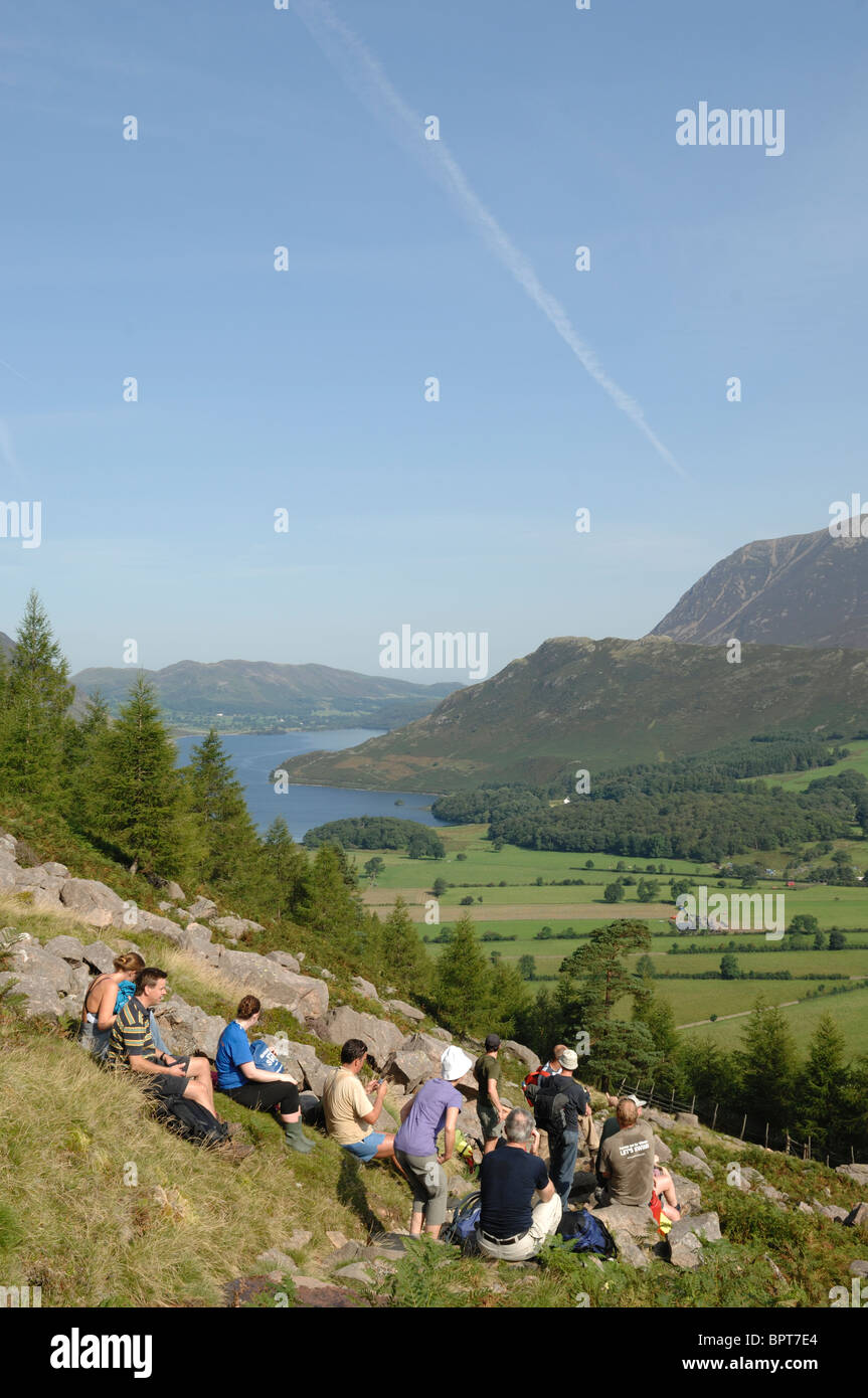 Group of walkers resting at Old Burtness on their way up Red Pike on a ...