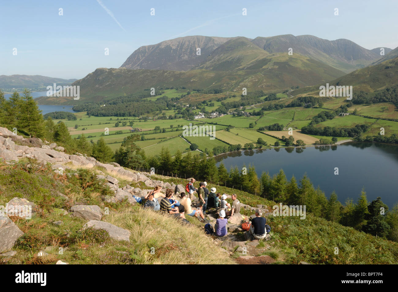 Group of walkers resting at Old Burtness on their way up Red Pike on a ...