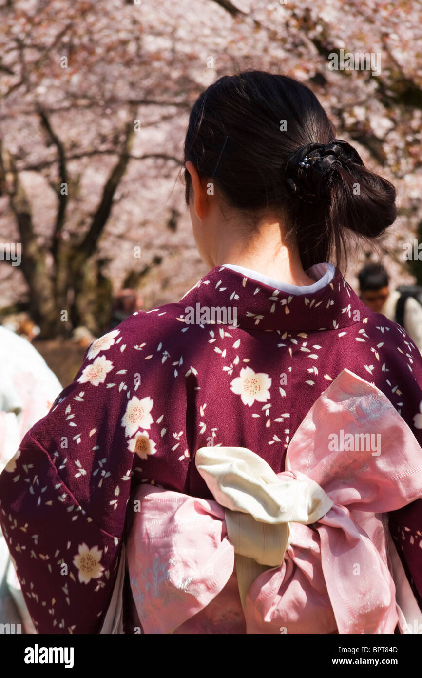 A Japanese woman in a pink and purple kimono during Hanami. Kyoto ...