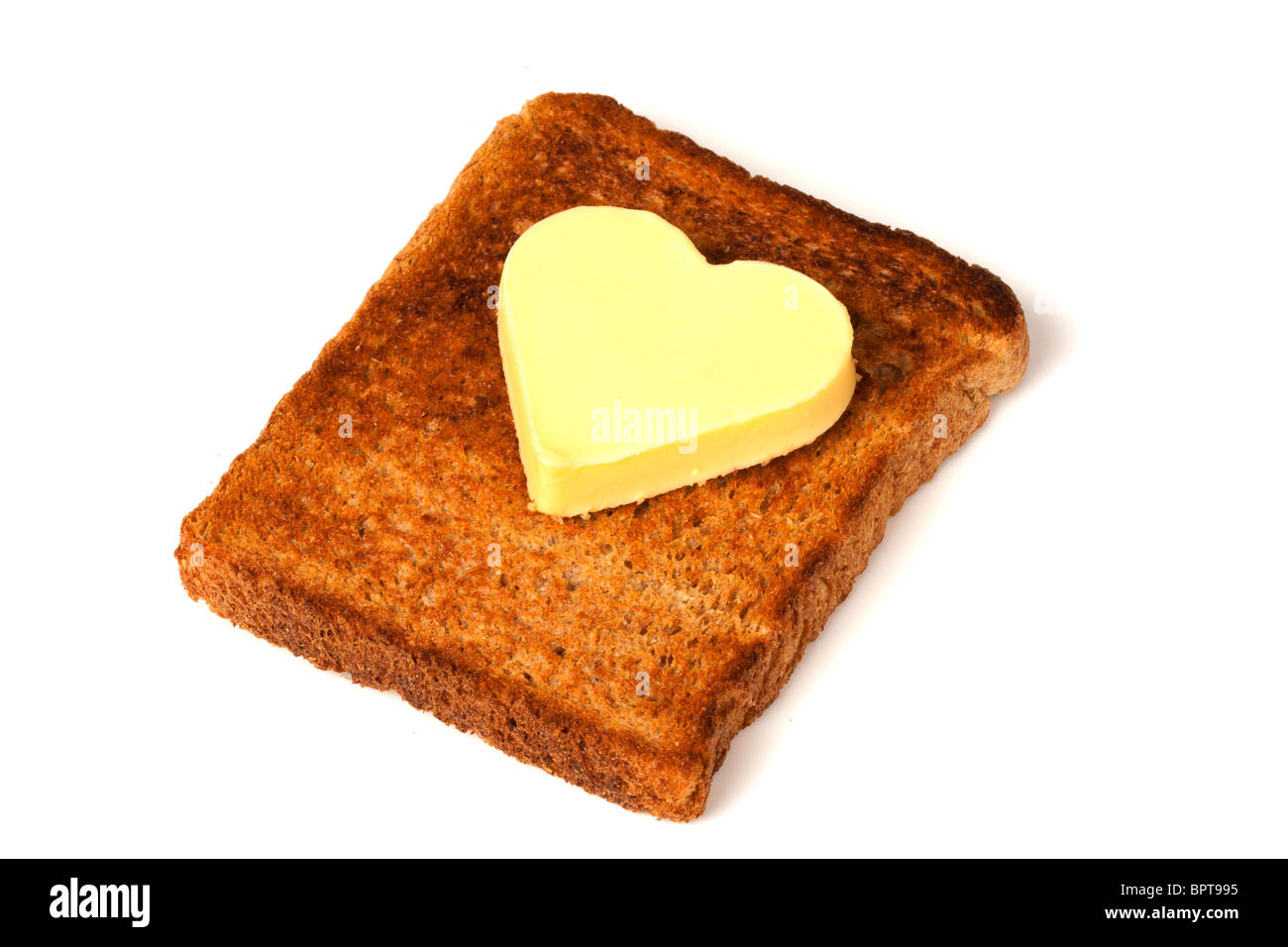 Heart Shaped Butter on wholemeal Toast on white background Stock Photo ...
