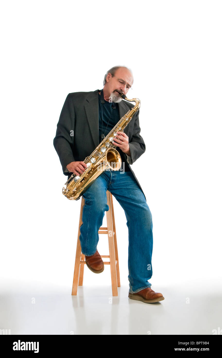 Adult male playing a tenor saxophone while seated isolated on pure ...