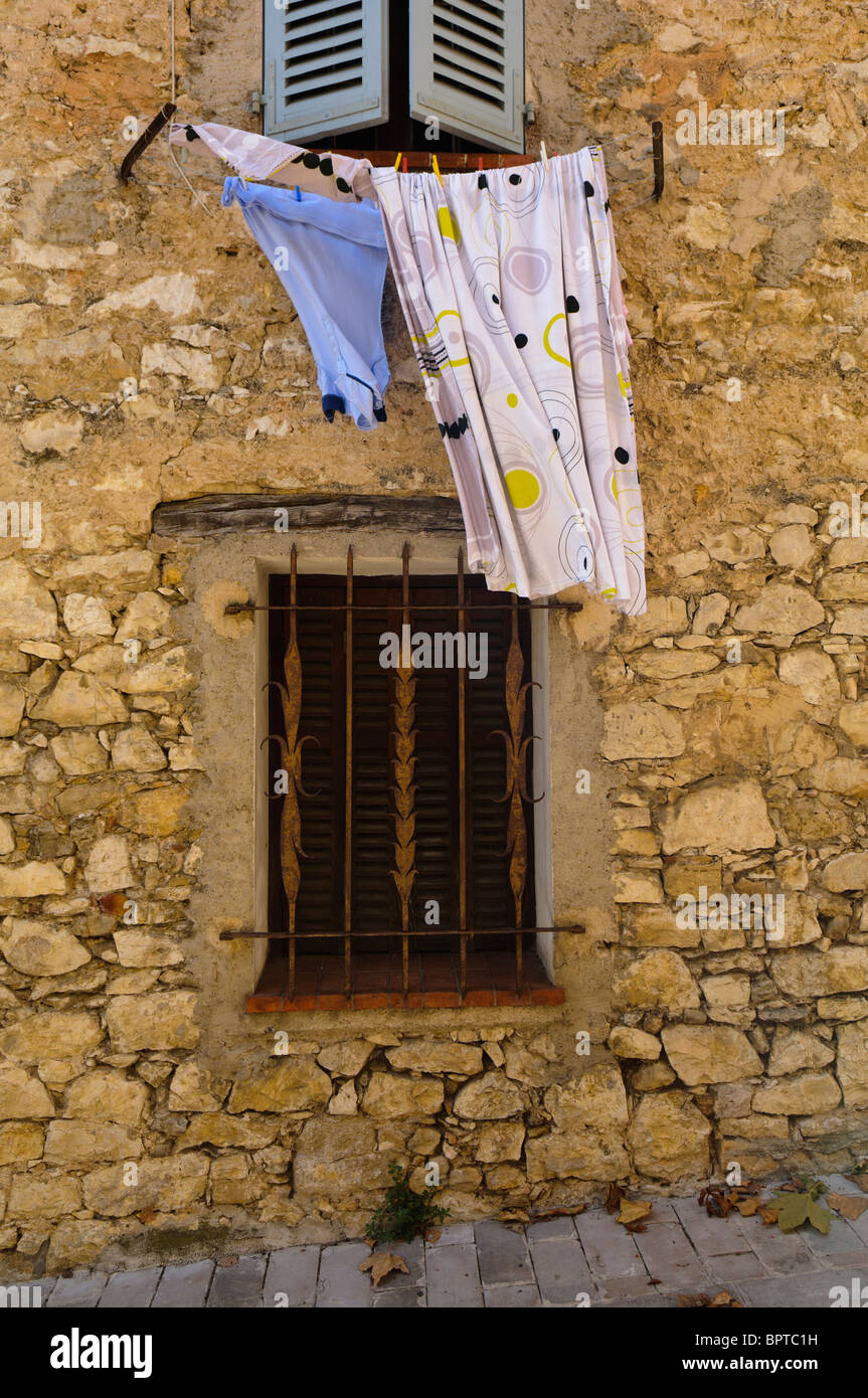 Laundry drying on a wall Stock Photo - Alamy