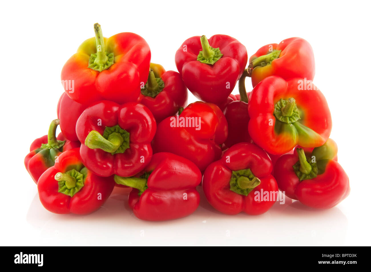 Many red whole fresh paprikas isolated over white Stock Photo - Alamy