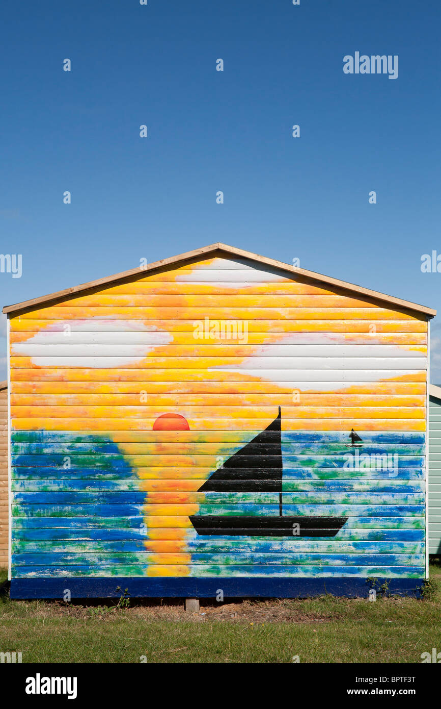 whitstable beach hut with brightly painted sunset scene Stock Photo - Alamy