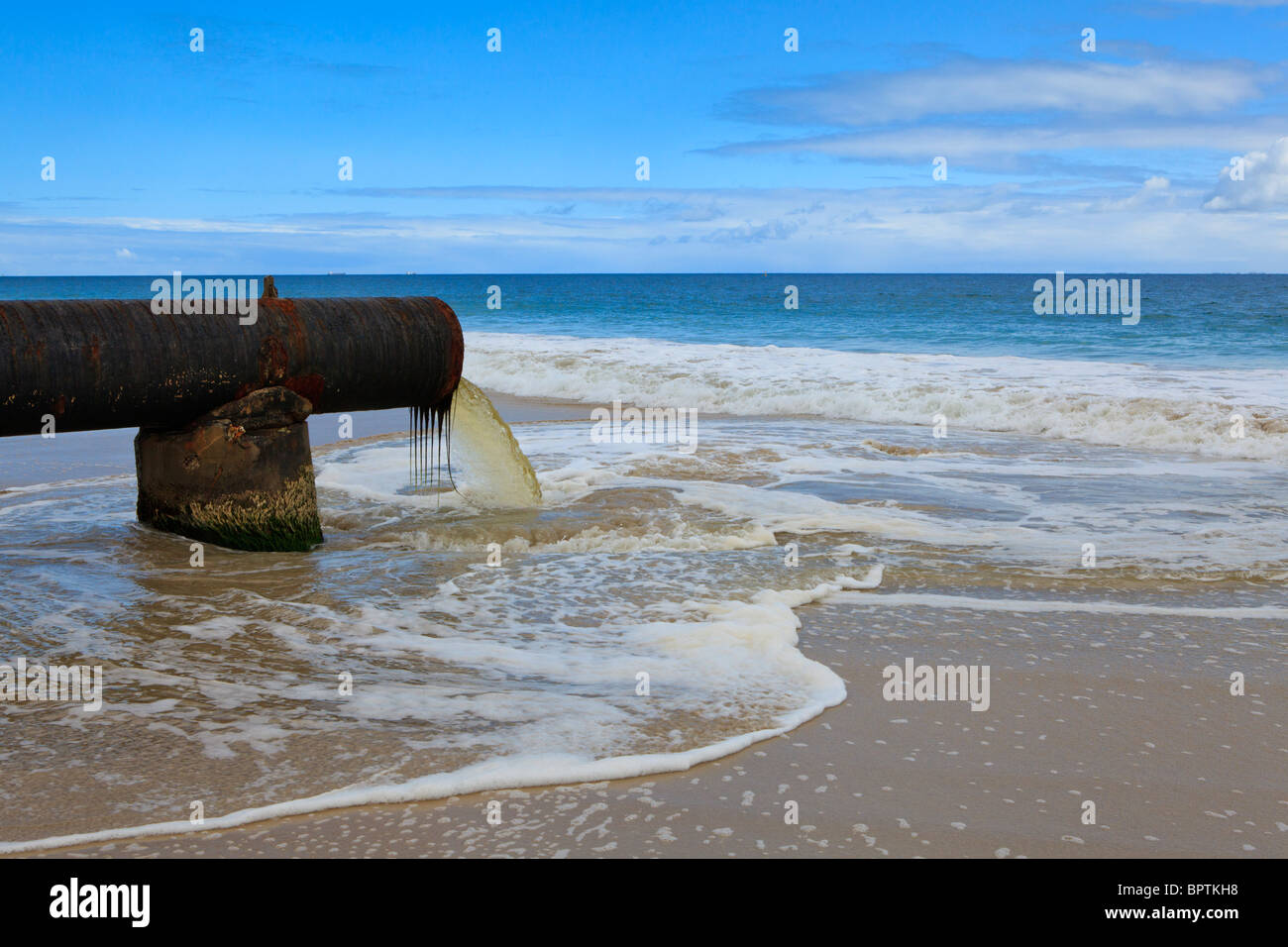 Rainwater drain pipe pouring out onto a beach Stock Photo - Alamy