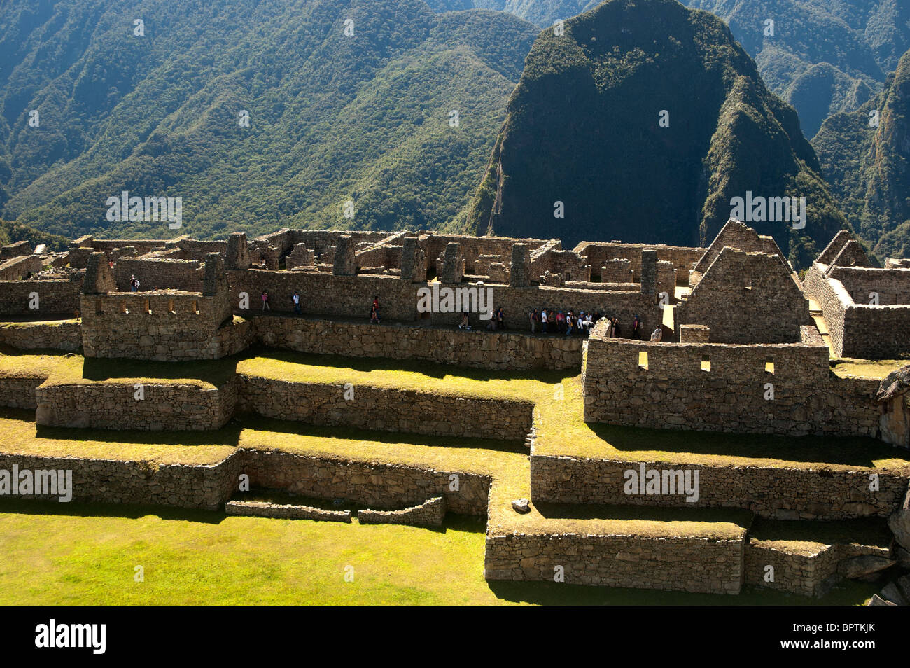 Tourists amidst the intricate stonework of ruined buildings at the ...