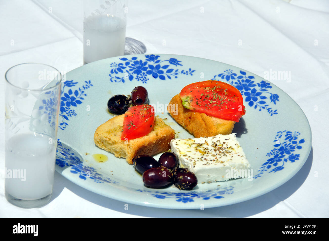 Greek Meze with Ouzo, Feta cheese, greek olives, tomatos on bread and ...
