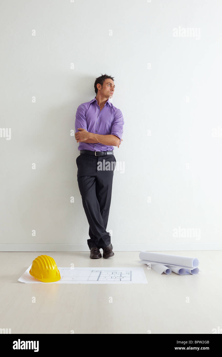 portrait of mid adult architect leaning on wall Stock Photo - Alamy