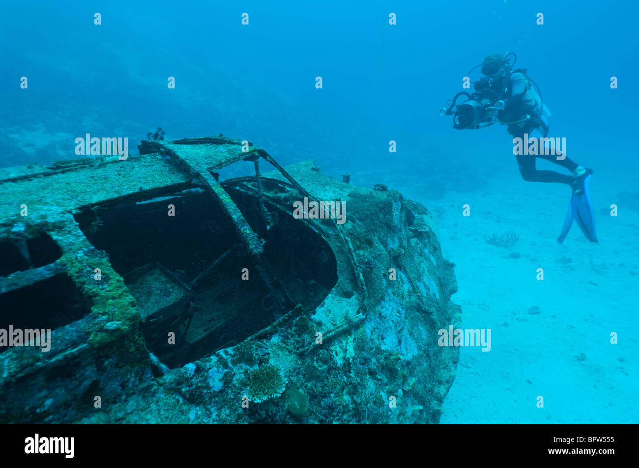 Cameraman filming the wreck of a PBY Catalina seaplane or flying boat ...