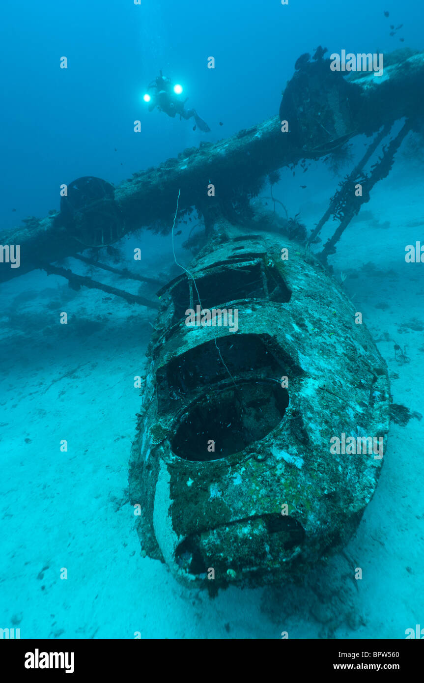 Cameraman filming the wreck of a PBY Catalina seaplane or flying boat ...